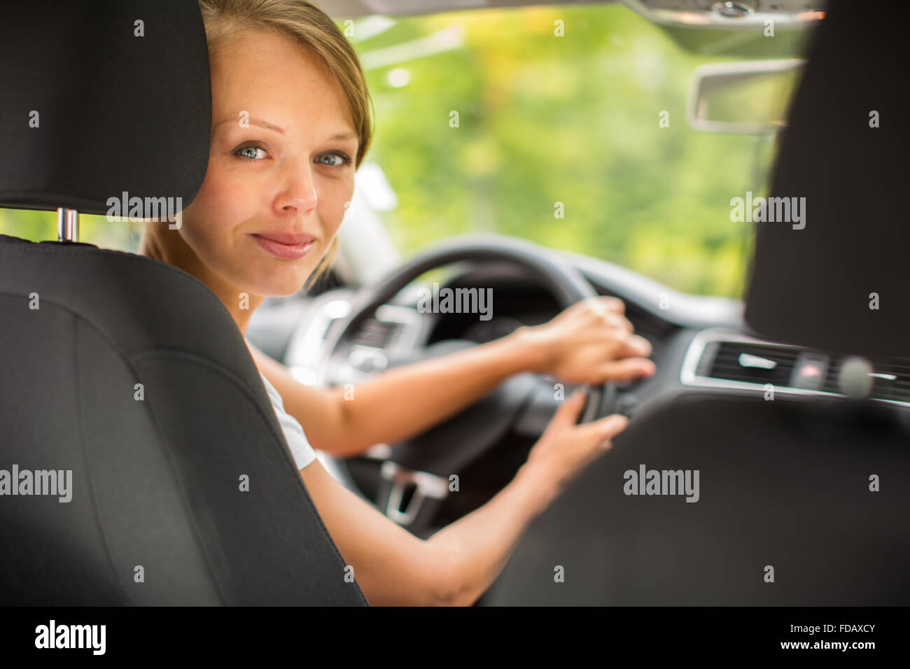 Young woman driving her car, on her way home from work - doing the ...