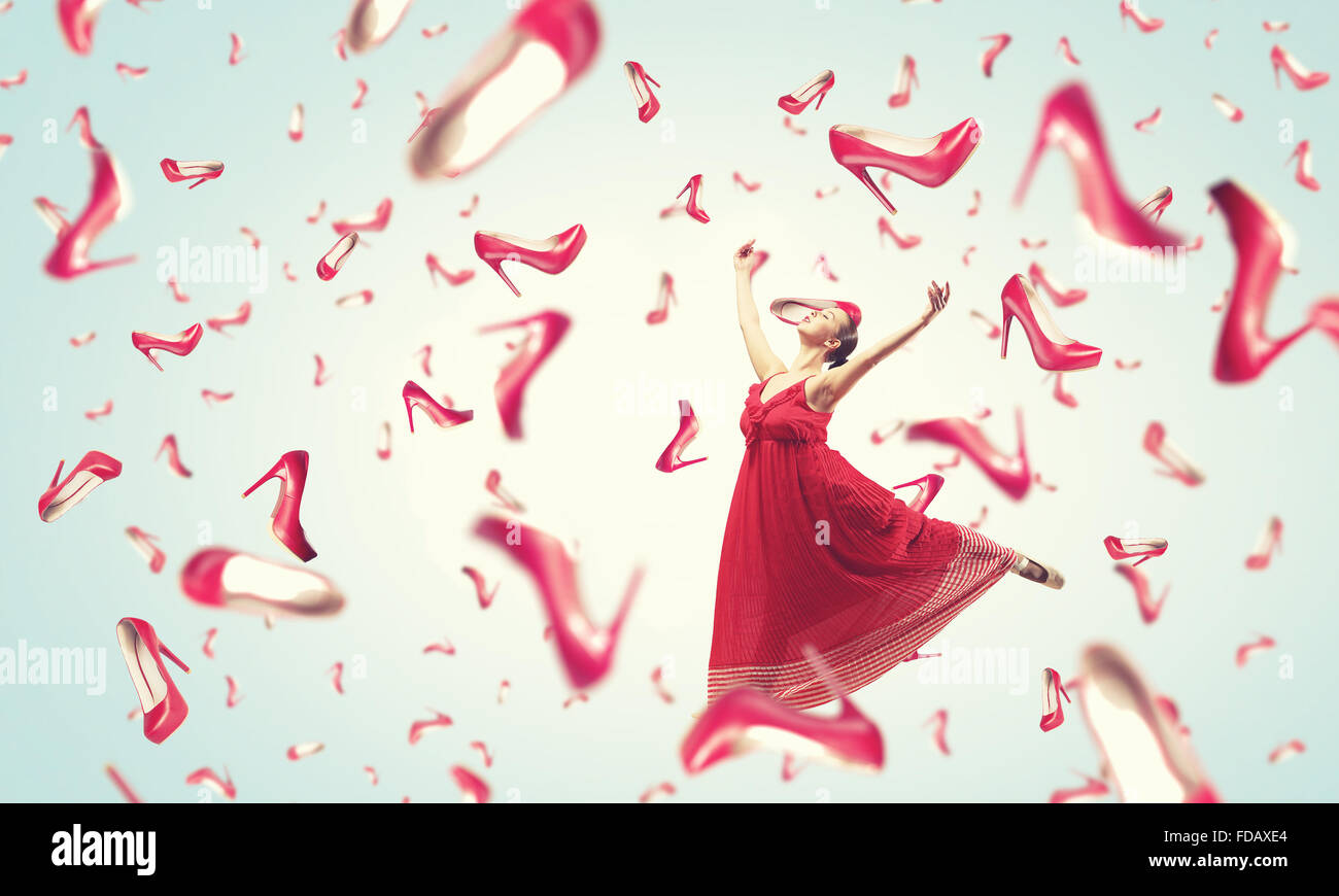 Young cheerful woman in dress and many falling shoes Stock Photo - Alamy