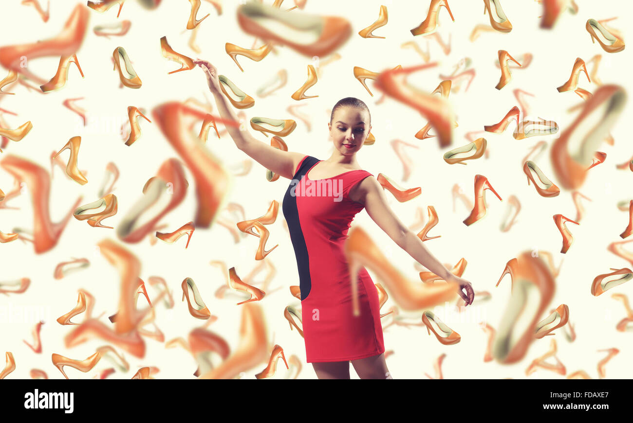 Young cheerful woman in dress and many falling shoes Stock Photo - Alamy