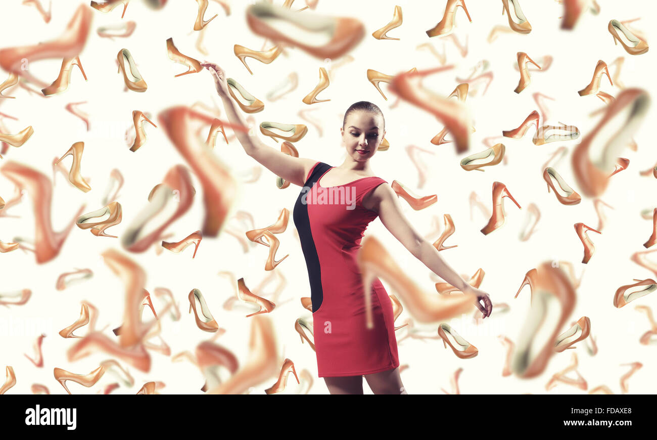 Young cheerful woman in dress and many falling shoes Stock Photo - Alamy