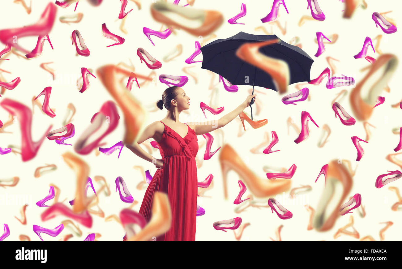 Young cheerful woman in dress and many falling shoes Stock Photo - Alamy