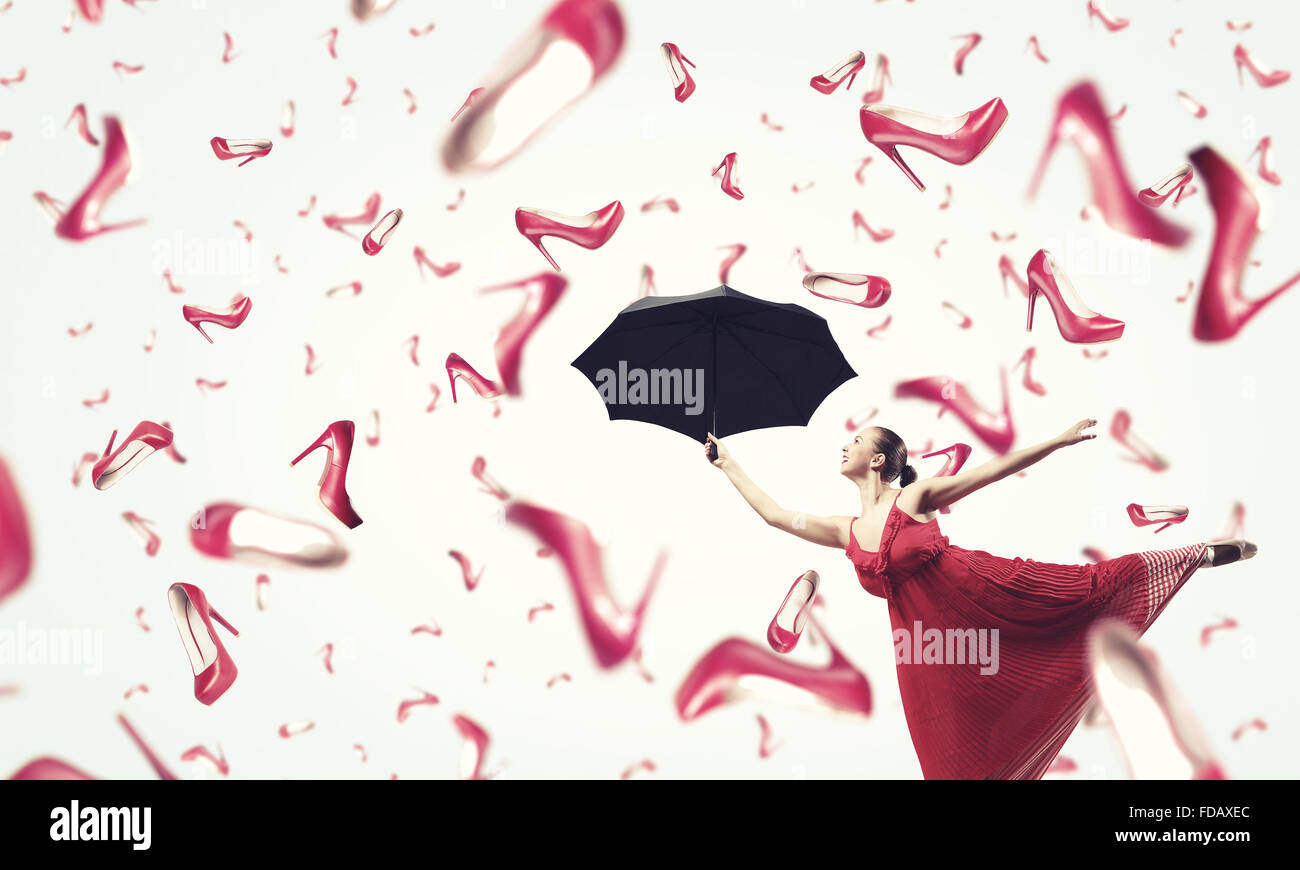 Young cheerful woman in dress and many falling shoes Stock Photo - Alamy