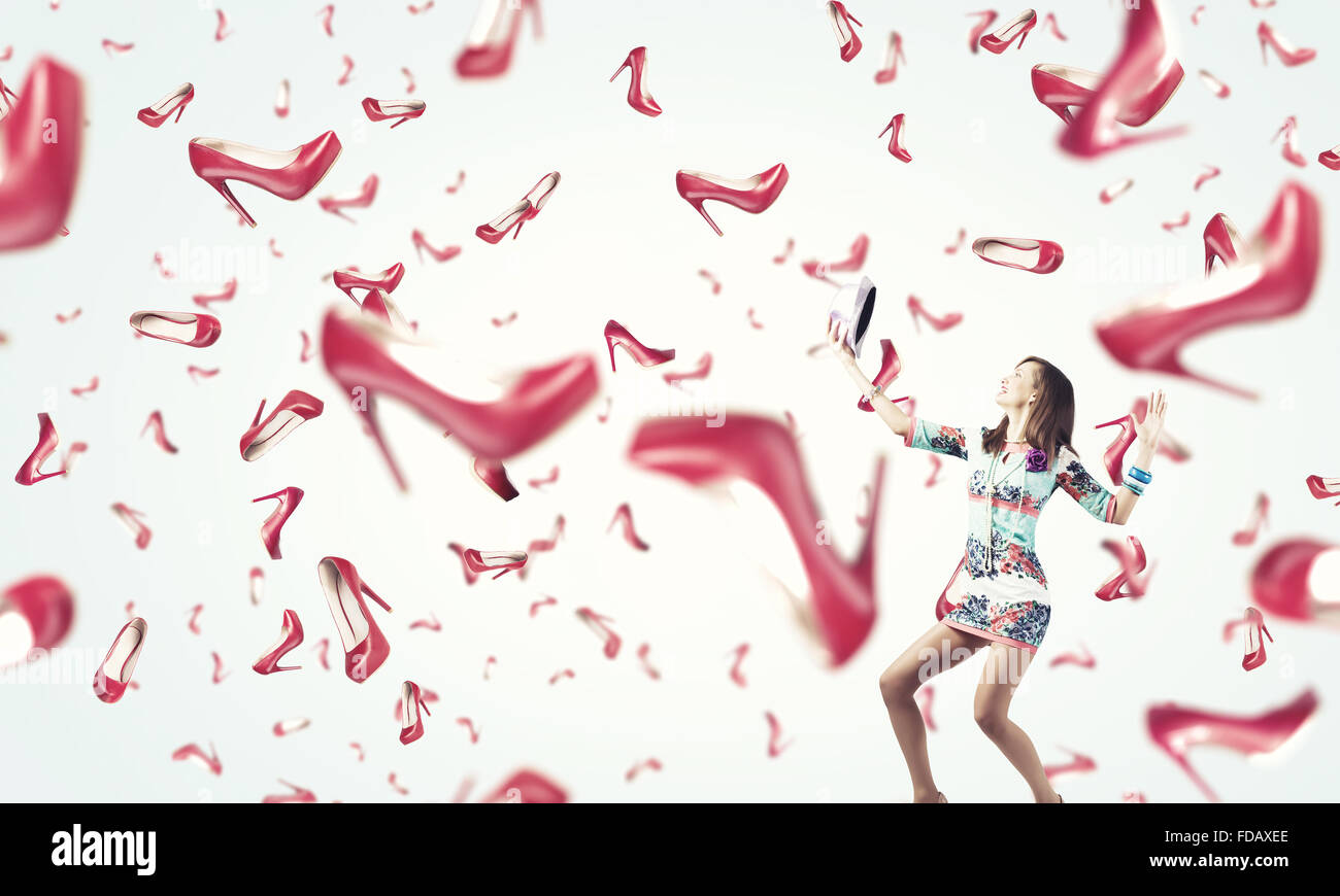 Young cheerful woman in dress and many falling shoes Stock Photo - Alamy