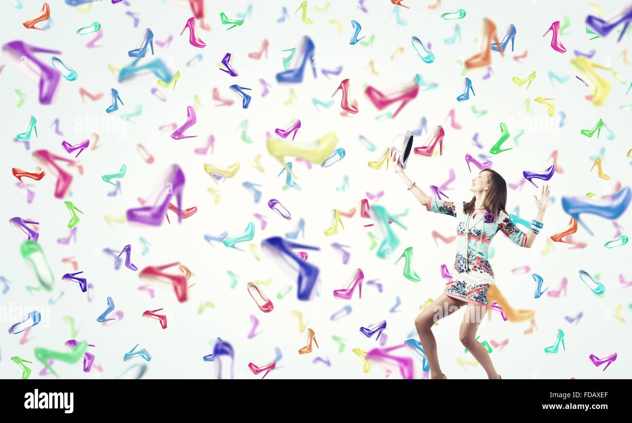 Young cheerful woman in dress and many falling shoes Stock Photo - Alamy