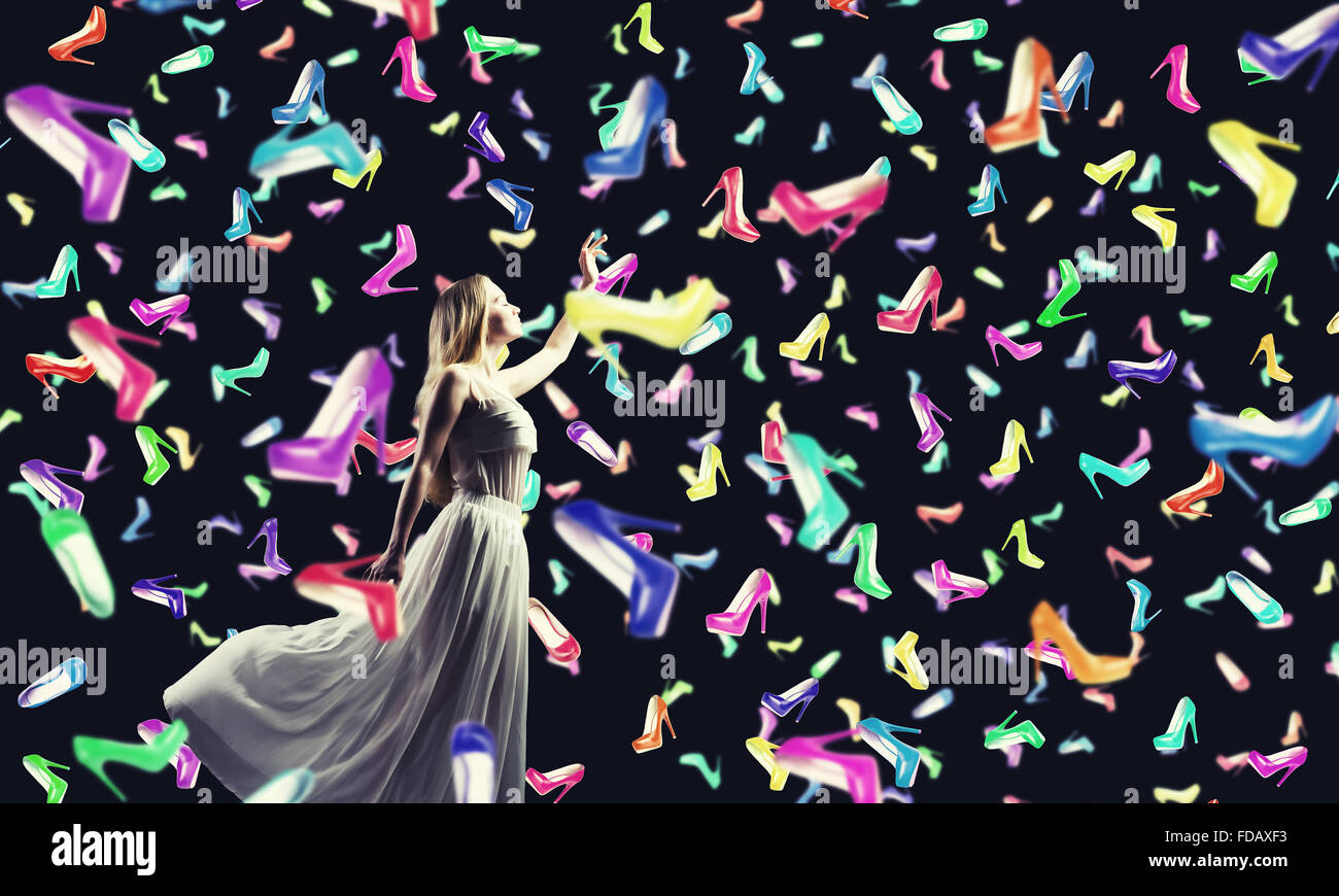 Young woman in white dress and many falling shoes Stock Photo - Alamy