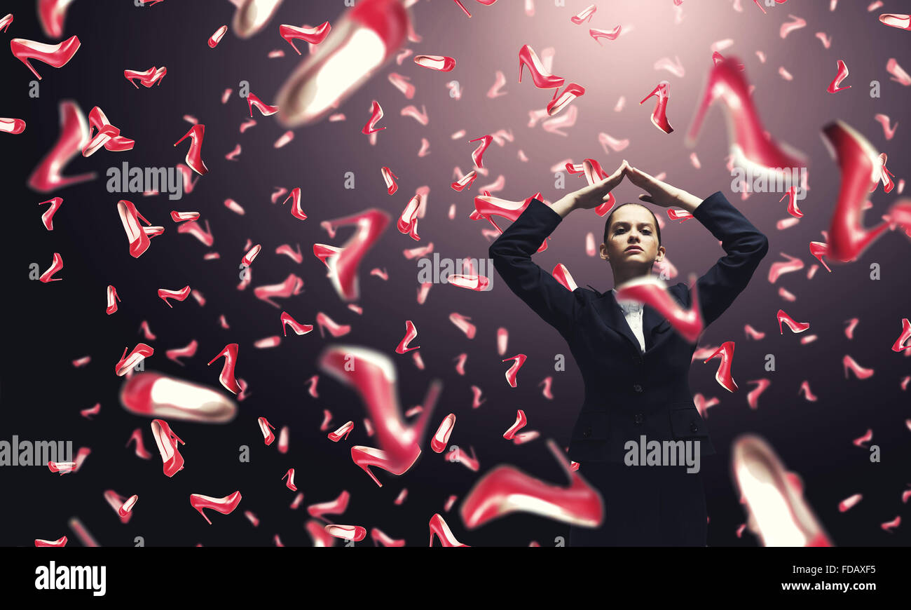 Young cheerful woman in suit and many falling shoes Stock Photo - Alamy