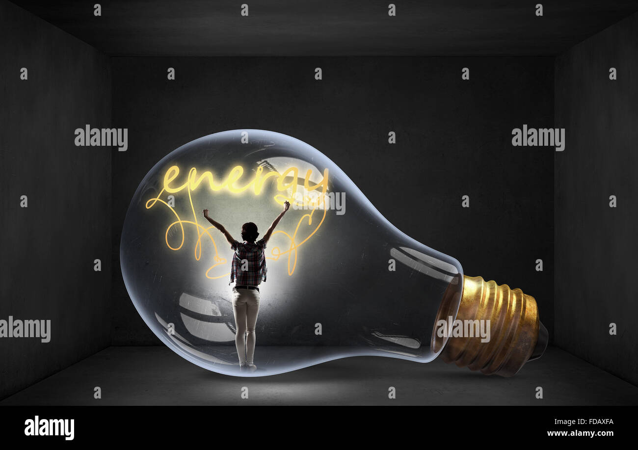 Cheerful girl inside of glass light bulb Stock Photo - Alamy