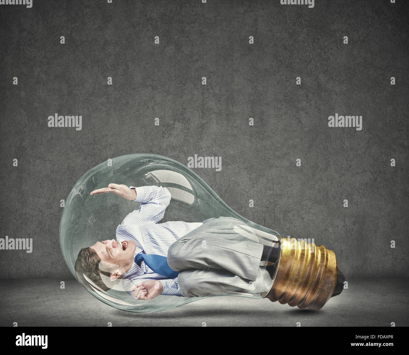 Screaming businessman trapped inside of light bulb Stock Photo - Alamy