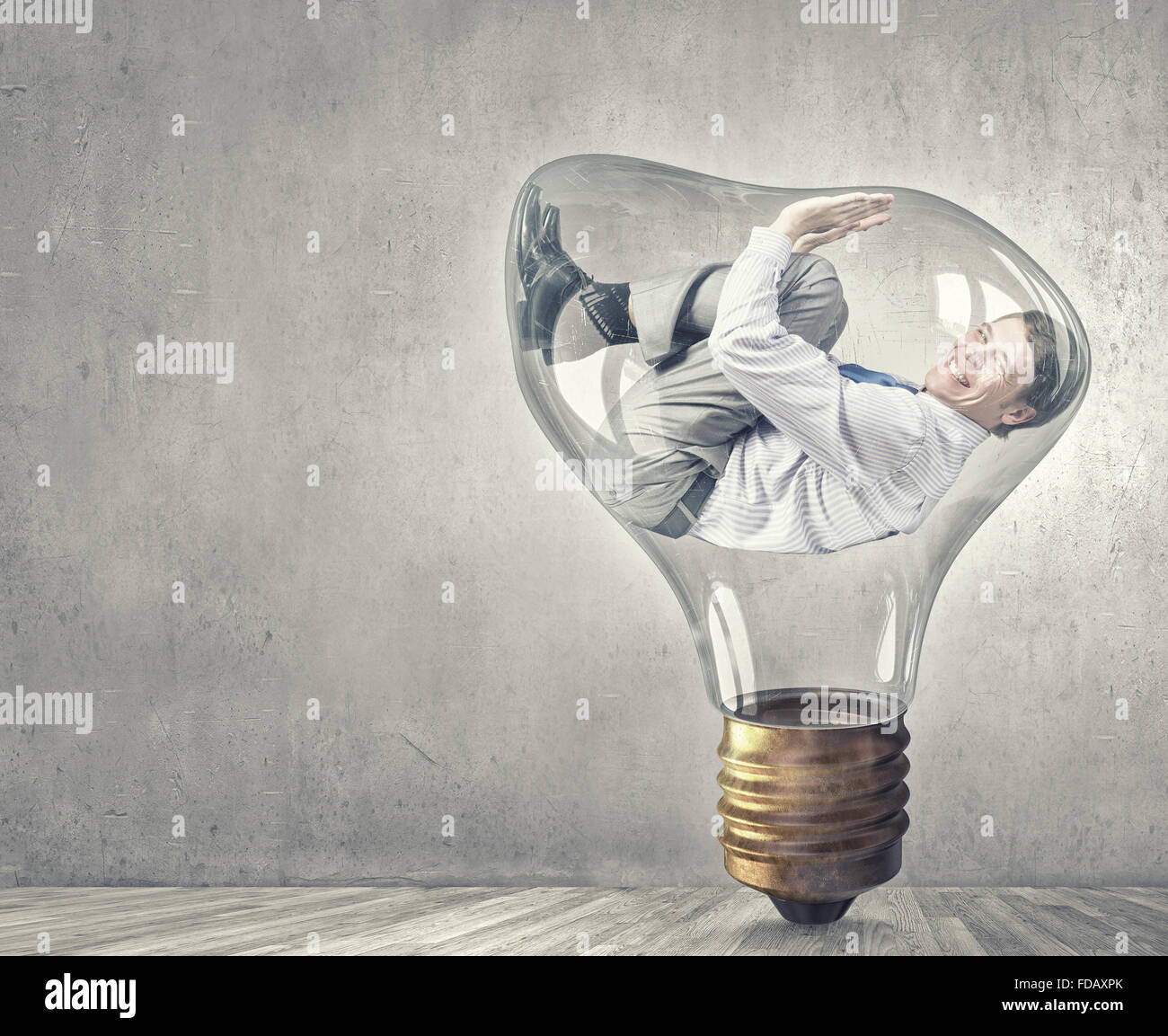 Screaming businessman trapped inside of light bulb Stock Photo - Alamy