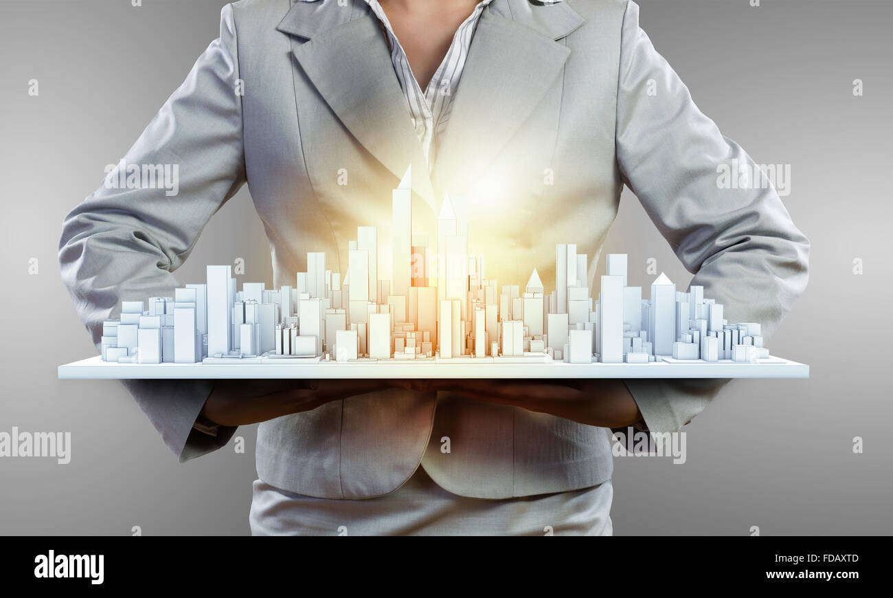 Close up of businesswoman hands presenting building model Stock Photo ...