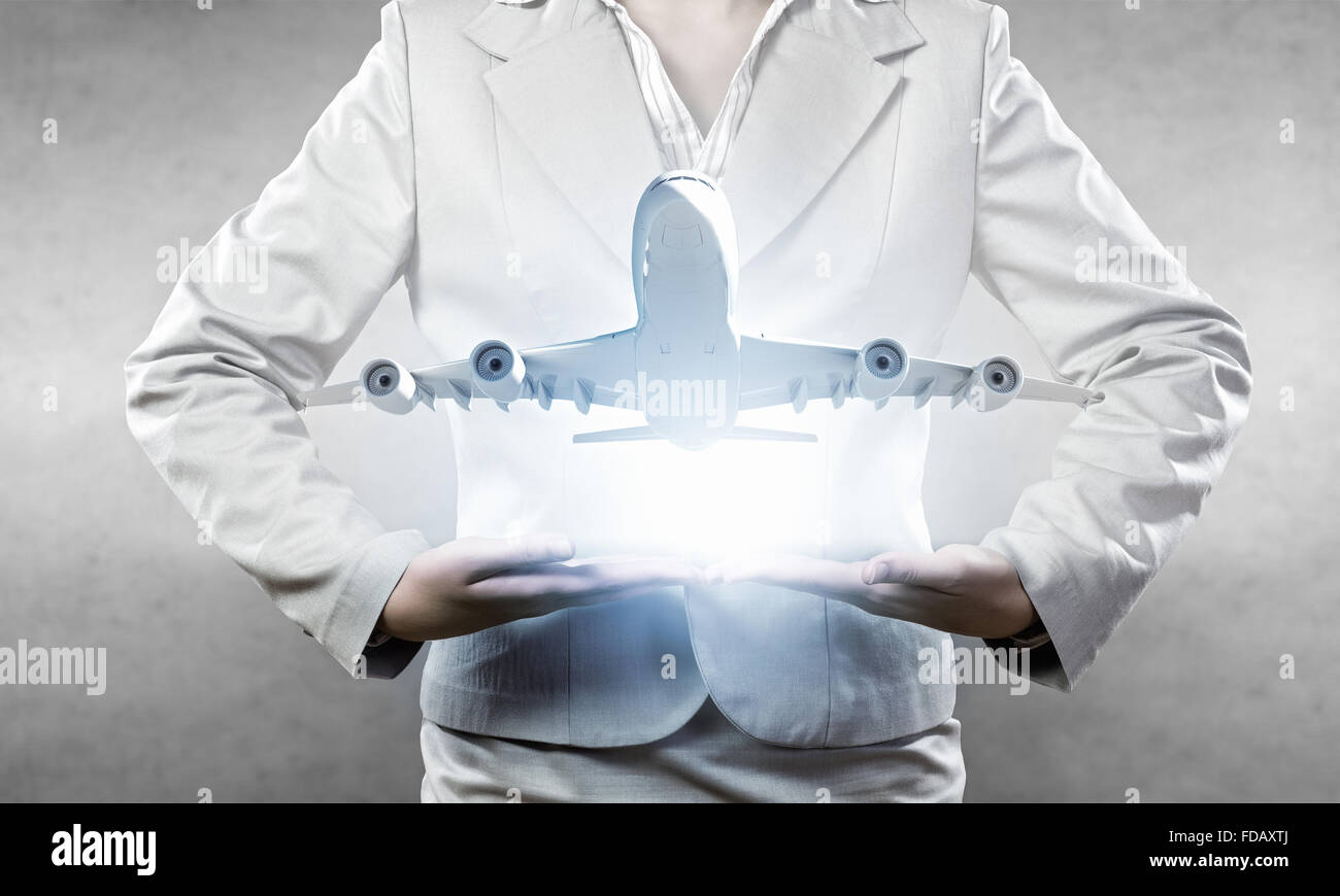 Close up of businesswoman hands holding airplane sign Stock Photo - Alamy