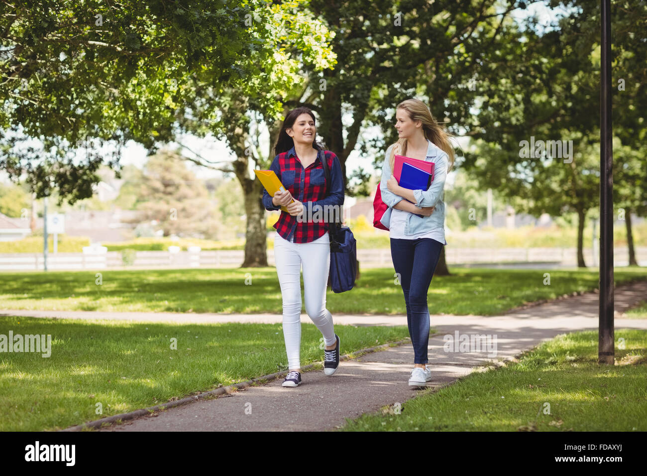 Smiling students holding binder Stock Photo - Alamy
