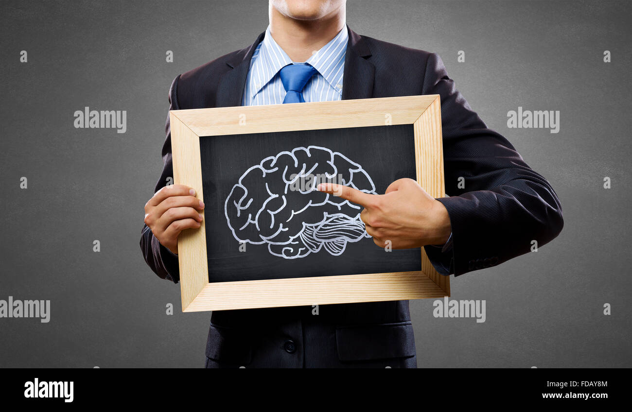 Close up of man holding chalkboard with human mind concept Stock Photo ...