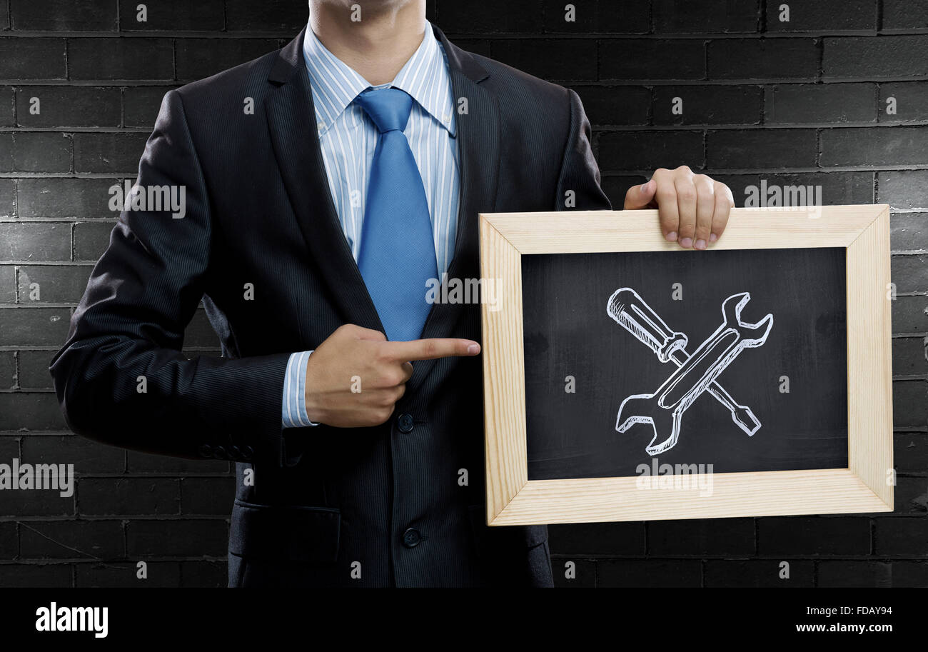 Unrecognizable businessman holding chalkboard with tools for success ...