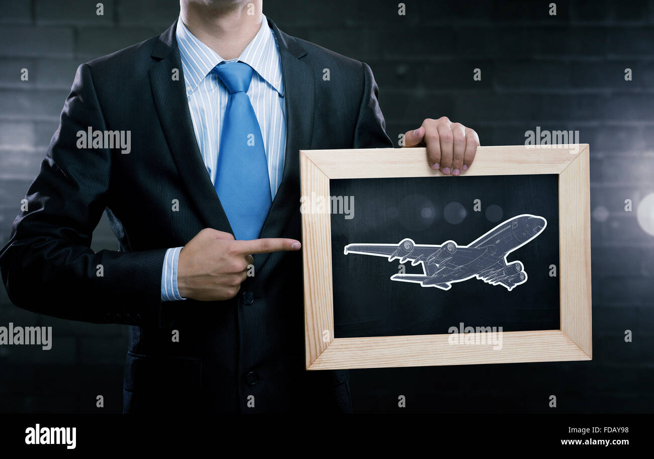 Close up of businessman holding chalkboard with airplane sketch hi-res ...