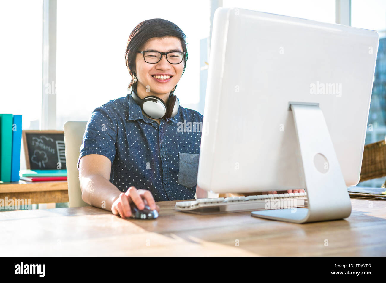 Smiling asian businessman using computer Stock Photo - Alamy