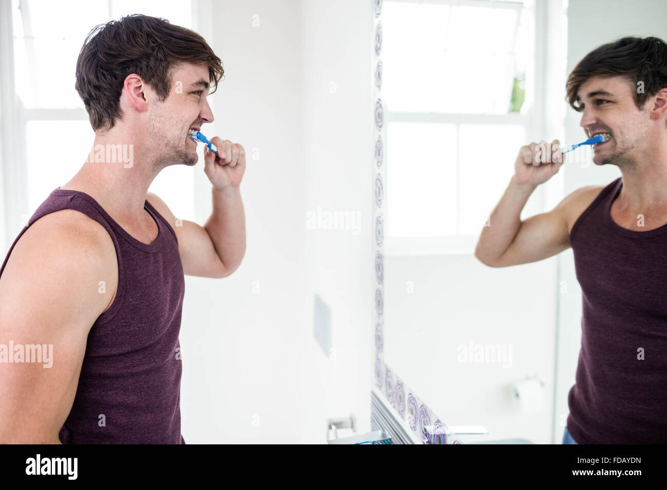 Handsome man cleaning his teeth Stock Photo - Alamy