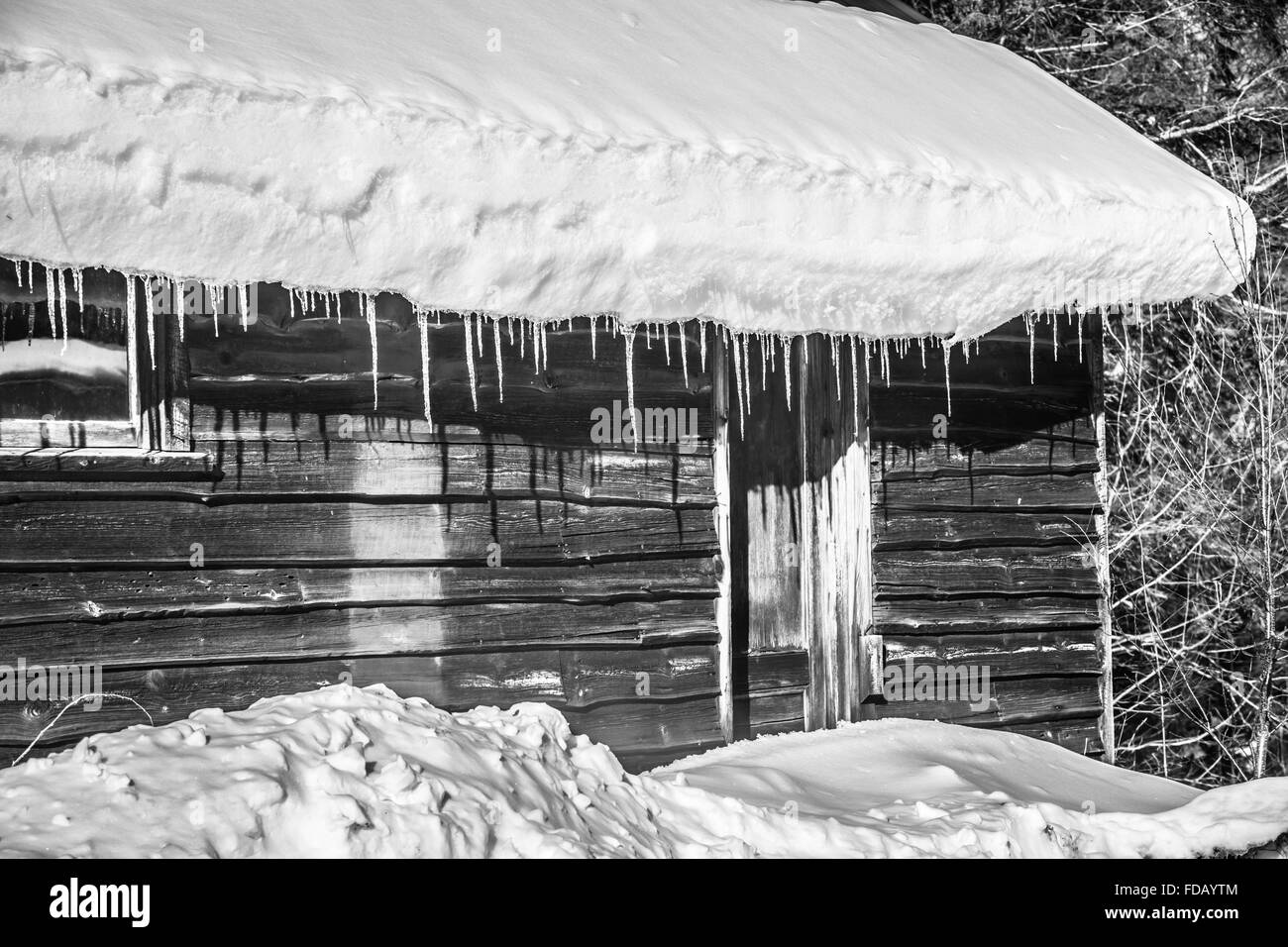 Icicle awning on cabin and snow Stock Photo - Alamy