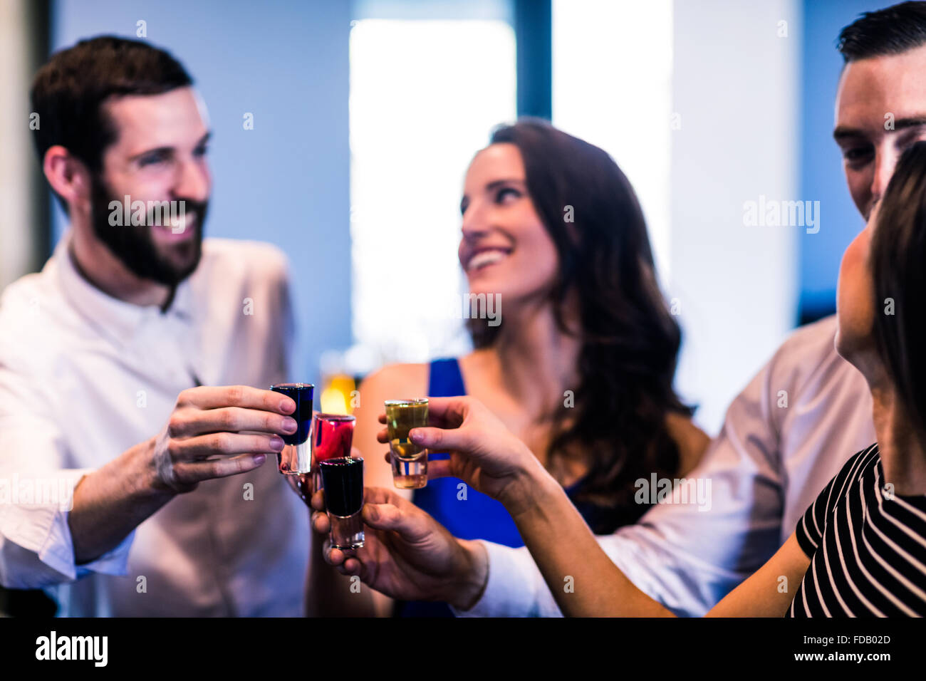 Friends toasting with alcohol shots Stock Photo - Alamy
