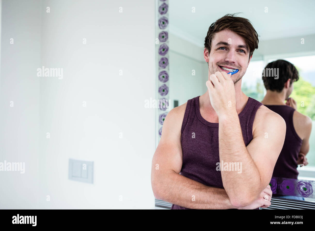 Handsome man cleaning his teeth Stock Photo - Alamy