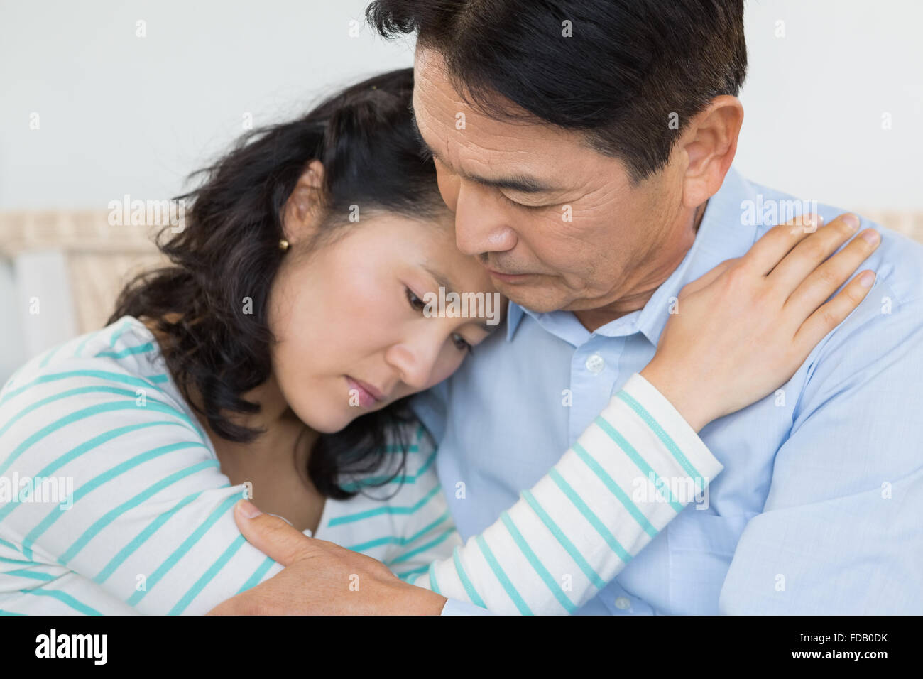Black couple embracing sad hi-res stock photography and images - Alamy