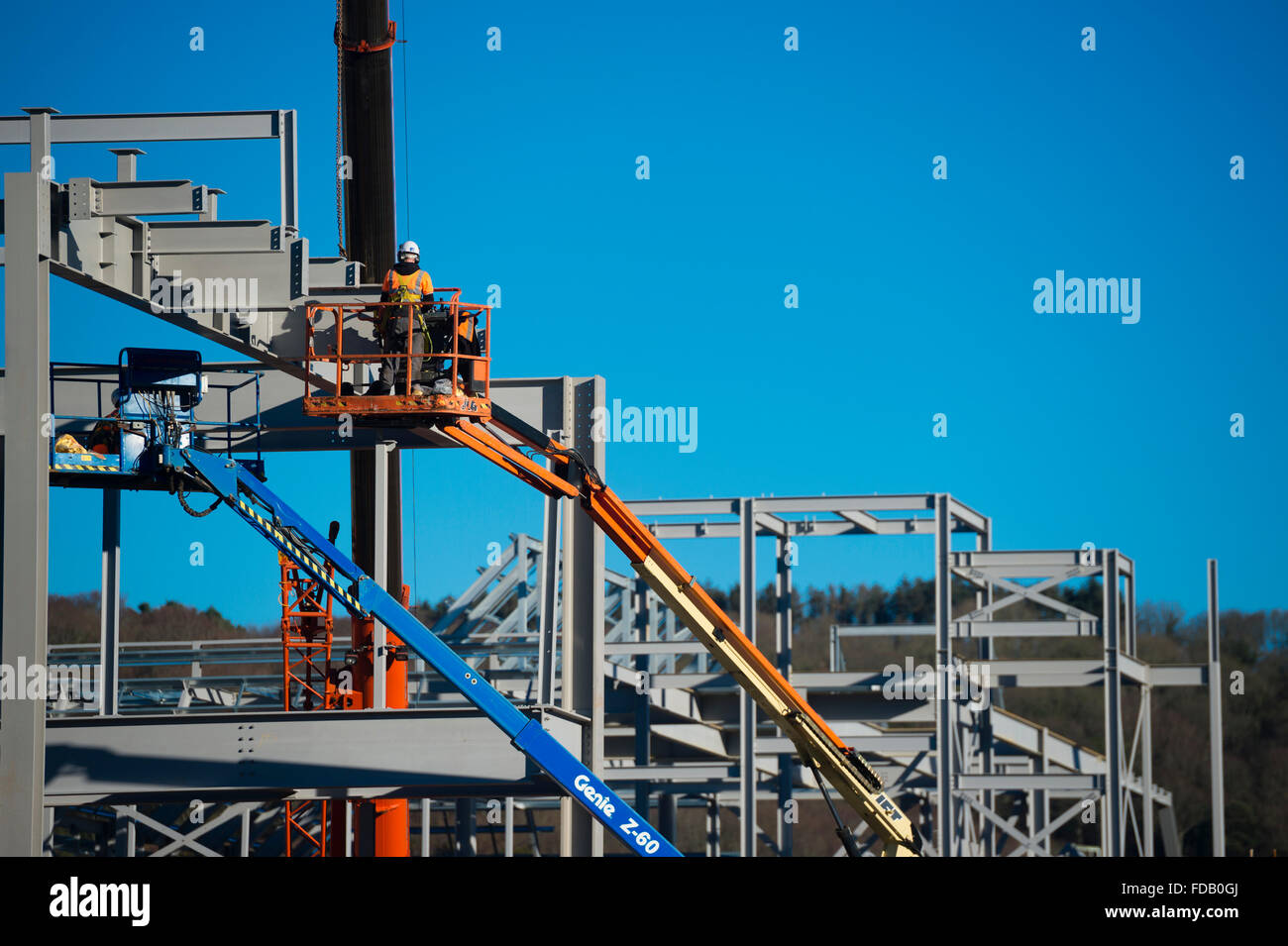 Men working at height from 'cherry picker' elevated platforms ...