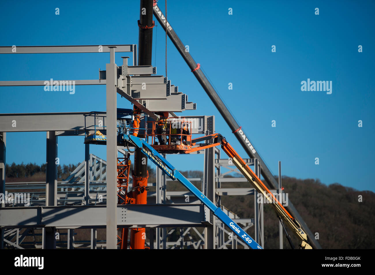 Men working at height from 'cherry picker' elevated platforms ...