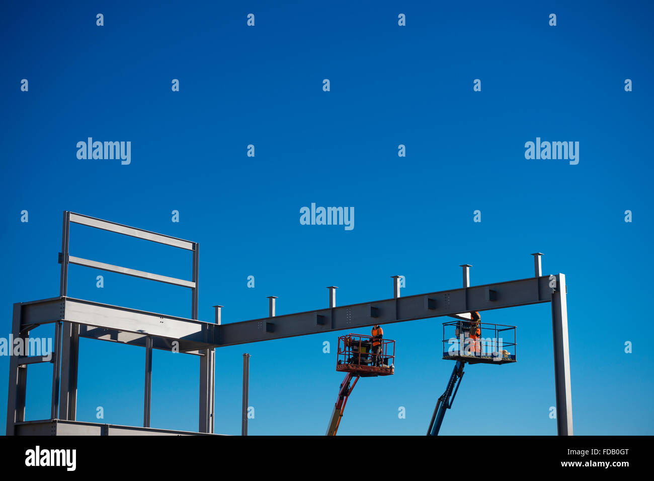 Men working at height from 'cherry picker' elevated platforms ...