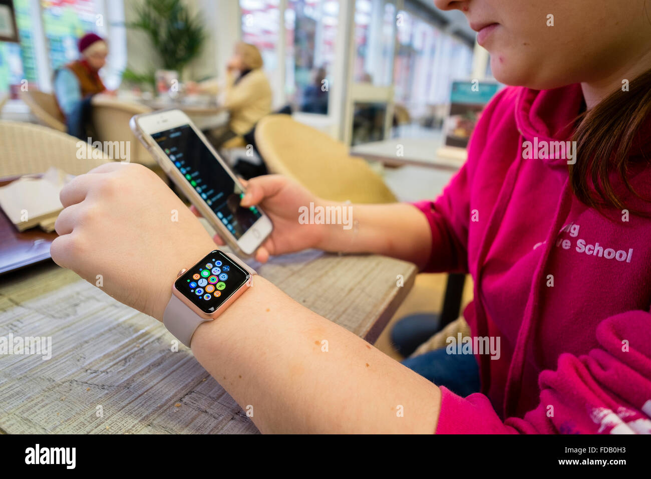 A young woman using an Apple iWatch, UK Stock Photo - Alamy