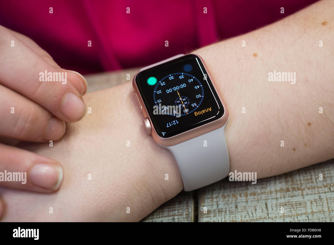 A young woman using an Apple iWatch, UK Stock Photo - Alamy