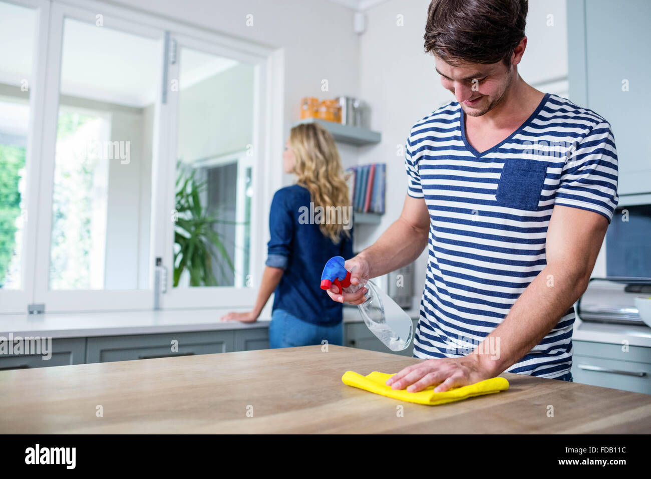 Cute couple cleaning up Stock Photo - Alamy