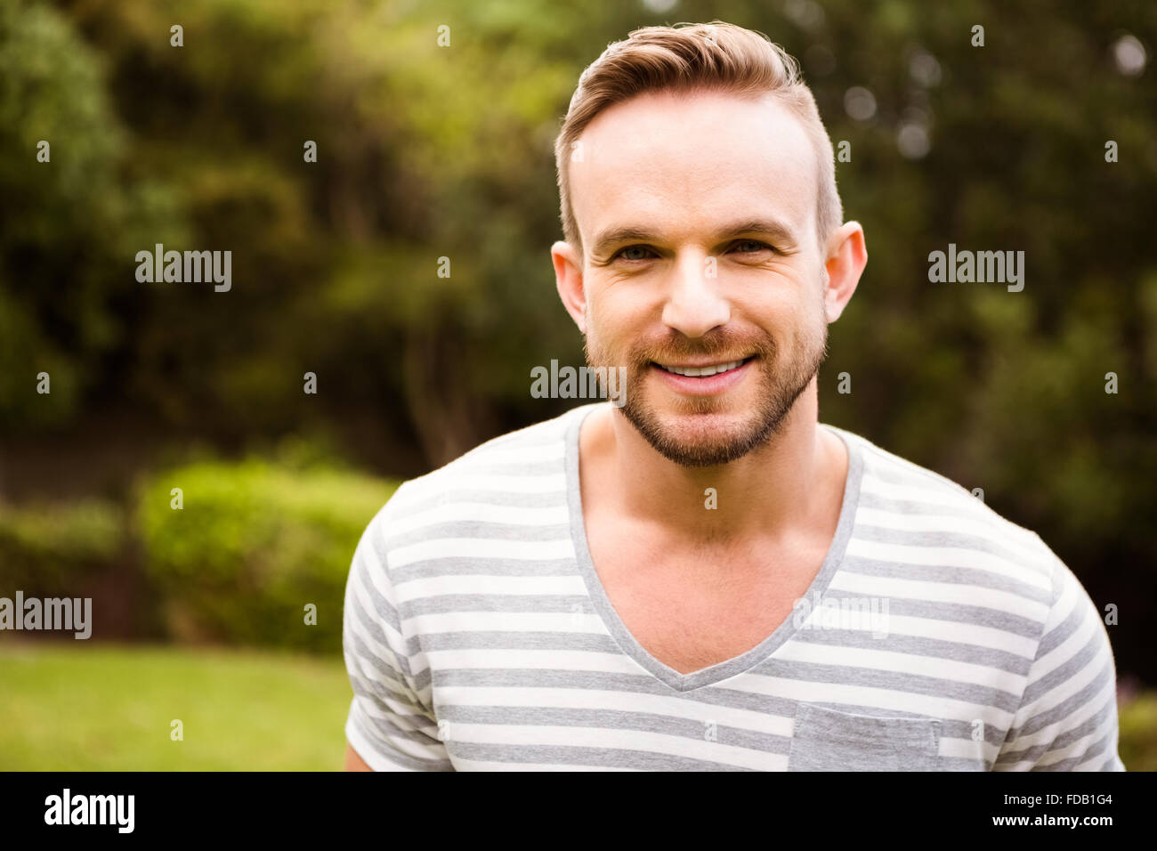 Smiling man posing for camera Stock Photo - Alamy