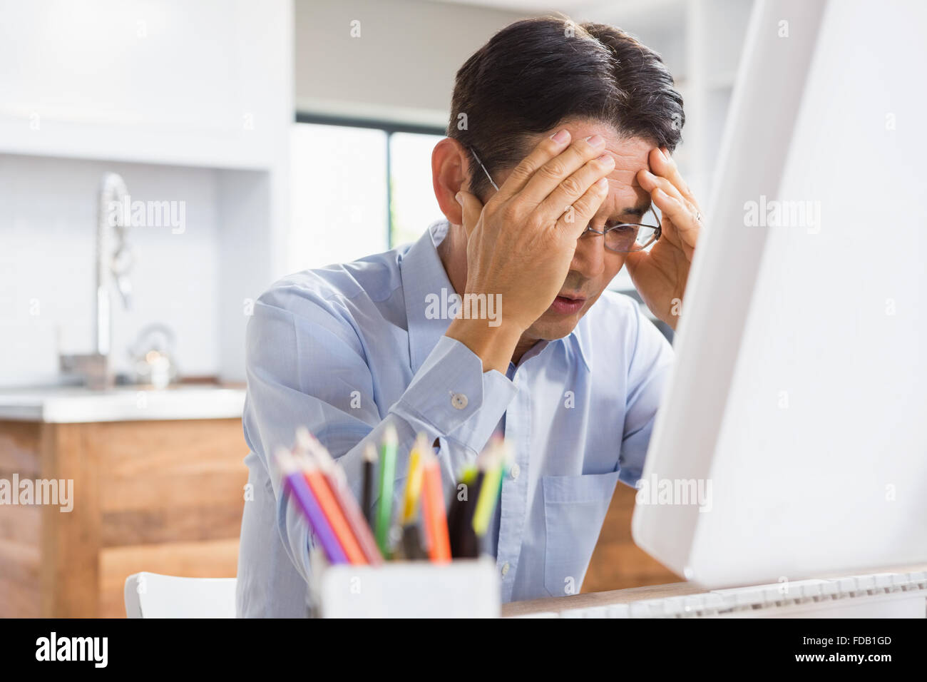 Suffering man with hands on face Stock Photo - Alamy