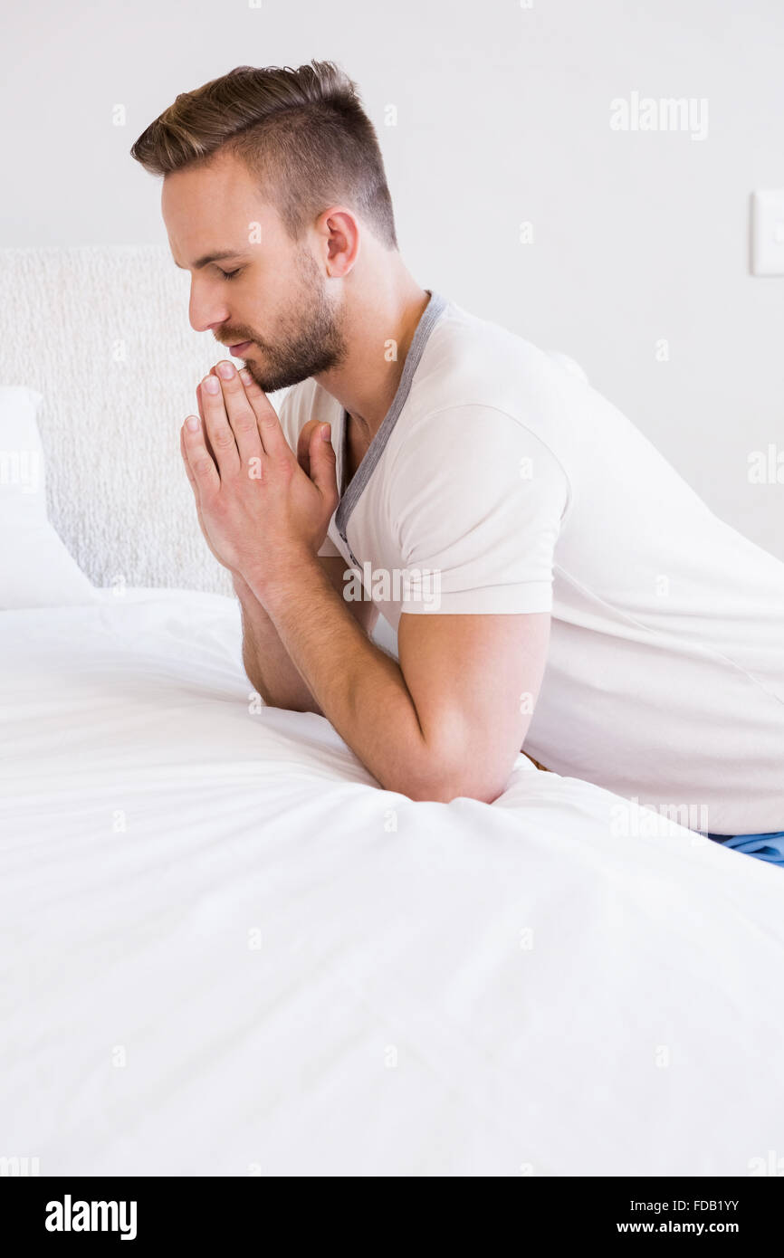 Concentrated man praying Stock Photo - Alamy