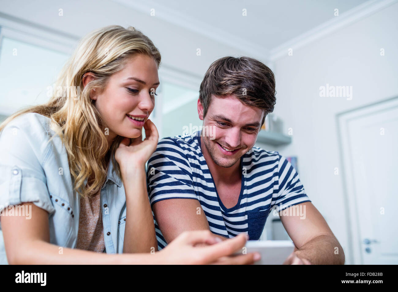 Focused couple using smartphone Stock Photo - Alamy