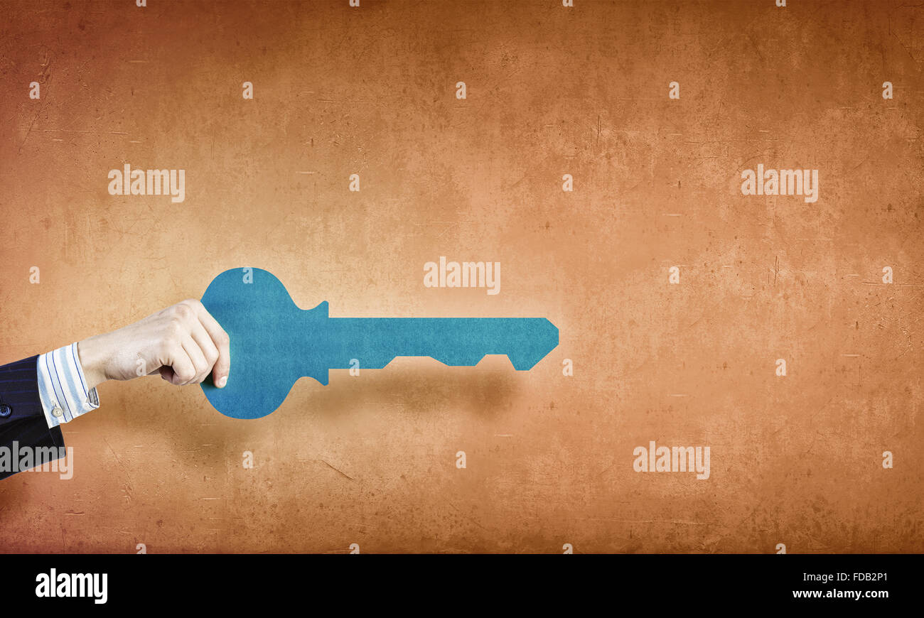 Hand of business person holding key card Stock Photo - Alamy