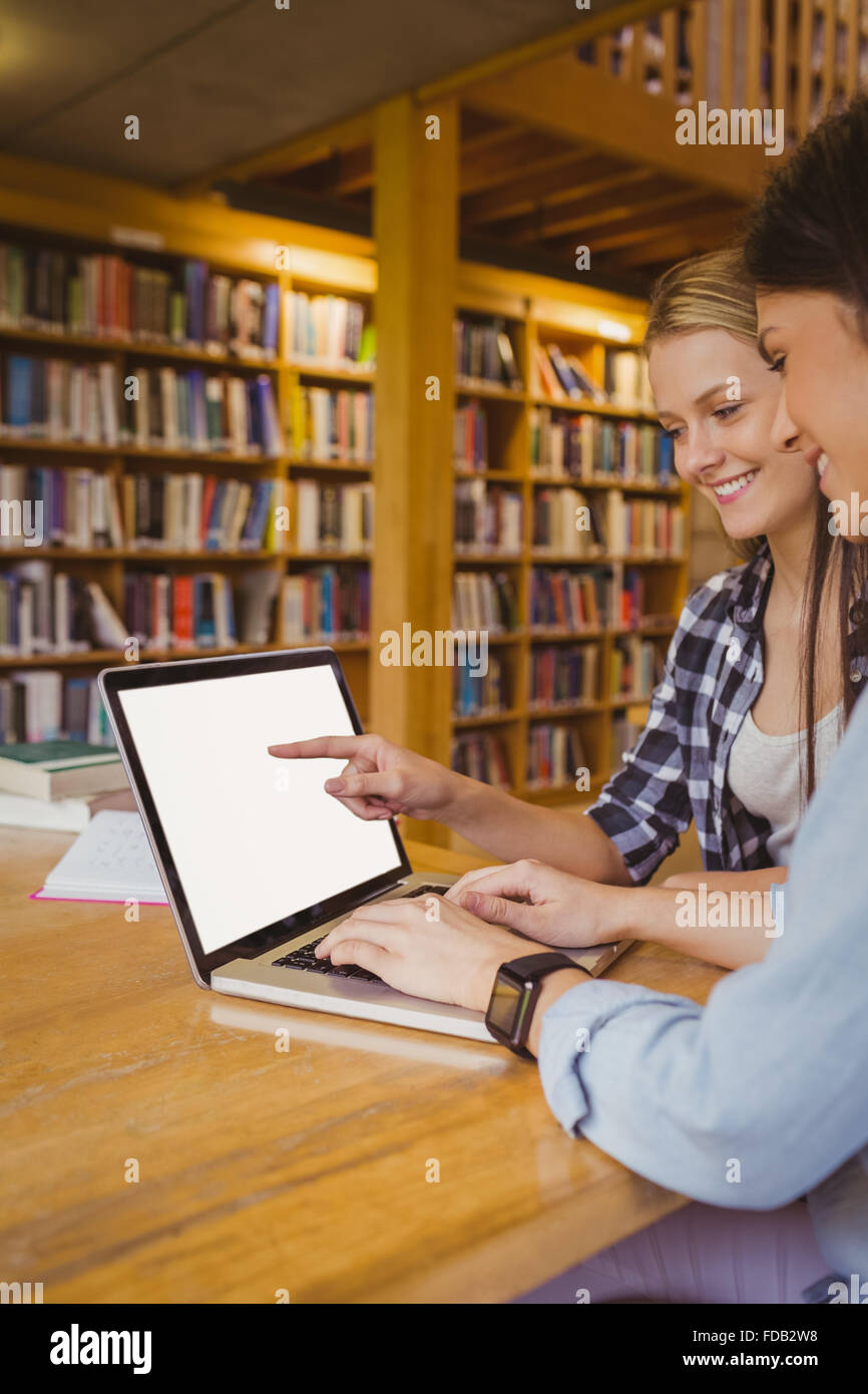 Smiling students using laptop Stock Photo - Alamy