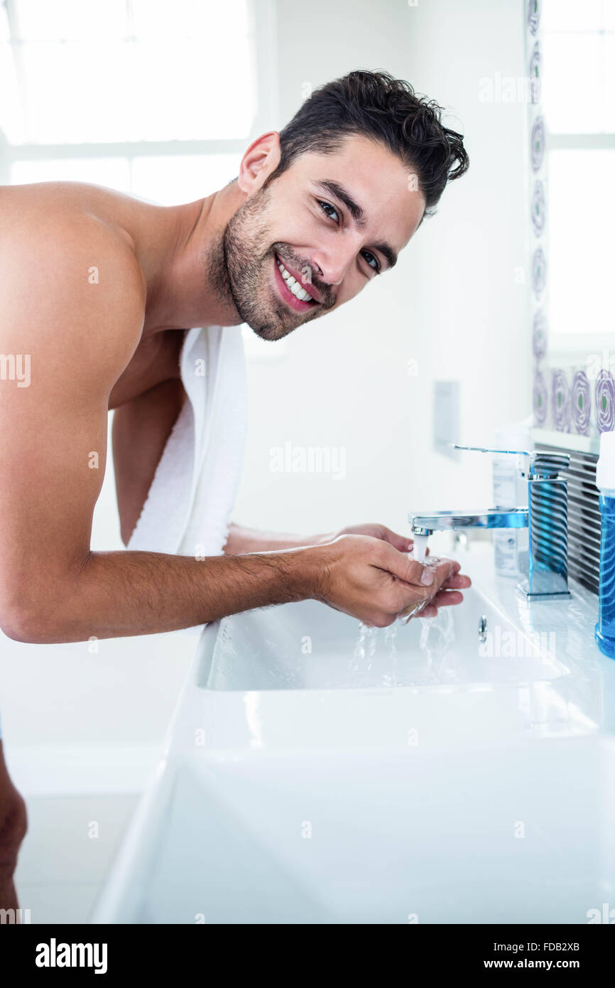 Man washing his face in sink Stock Photo - Alamy