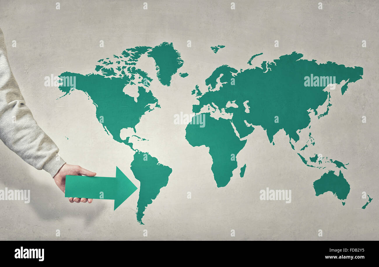 Close up of hand pointing with arrow at world map Stock Photo - Alamy