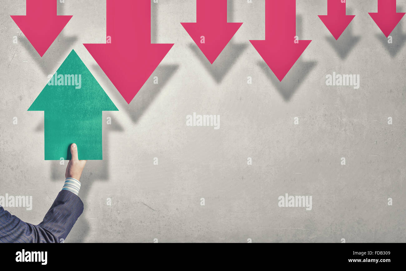 Hand of businessman holding green arrow pointing direction Stock Photo ...