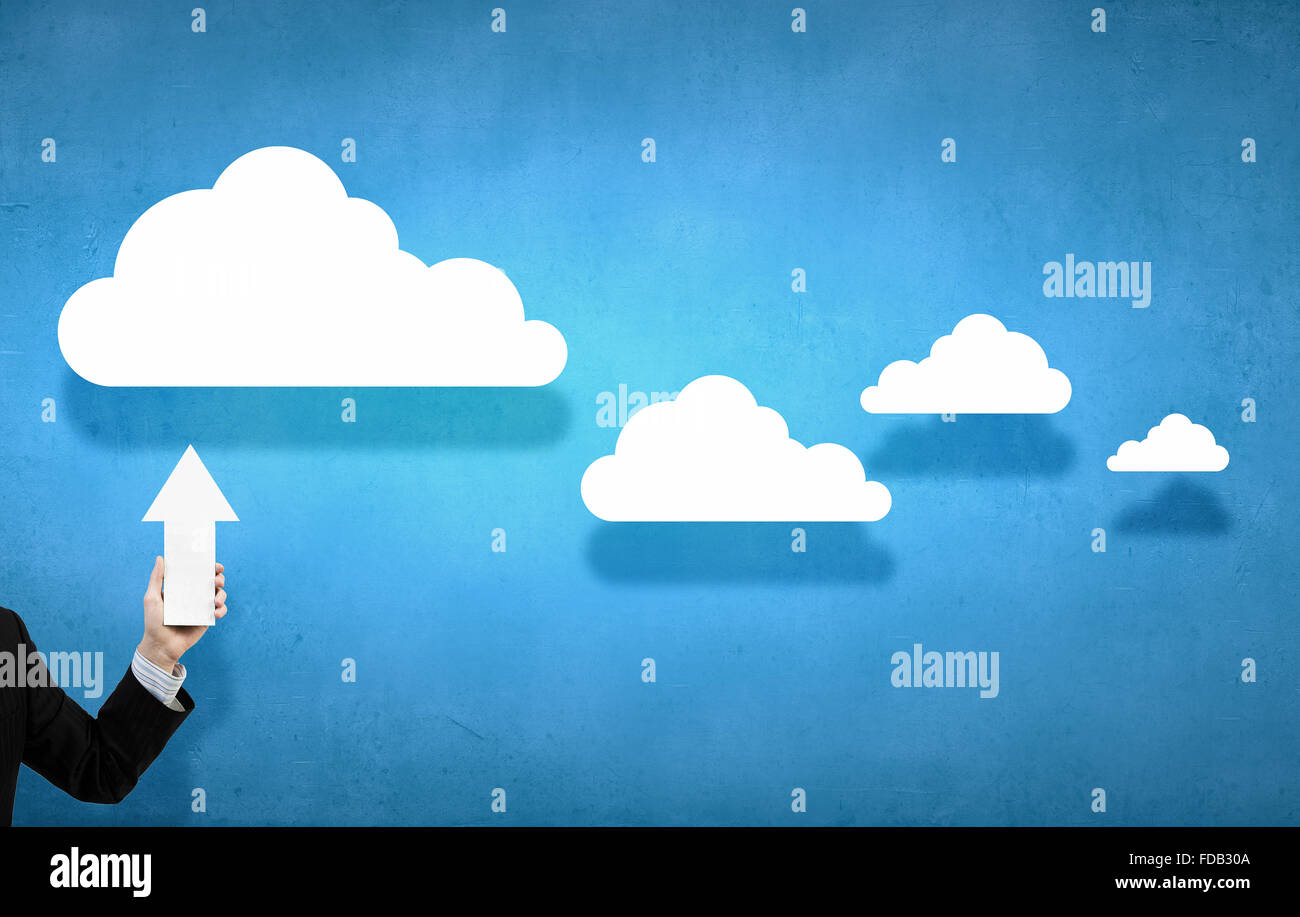 Close up of hand pointing with arrow at cloud concept Stock Photo - Alamy