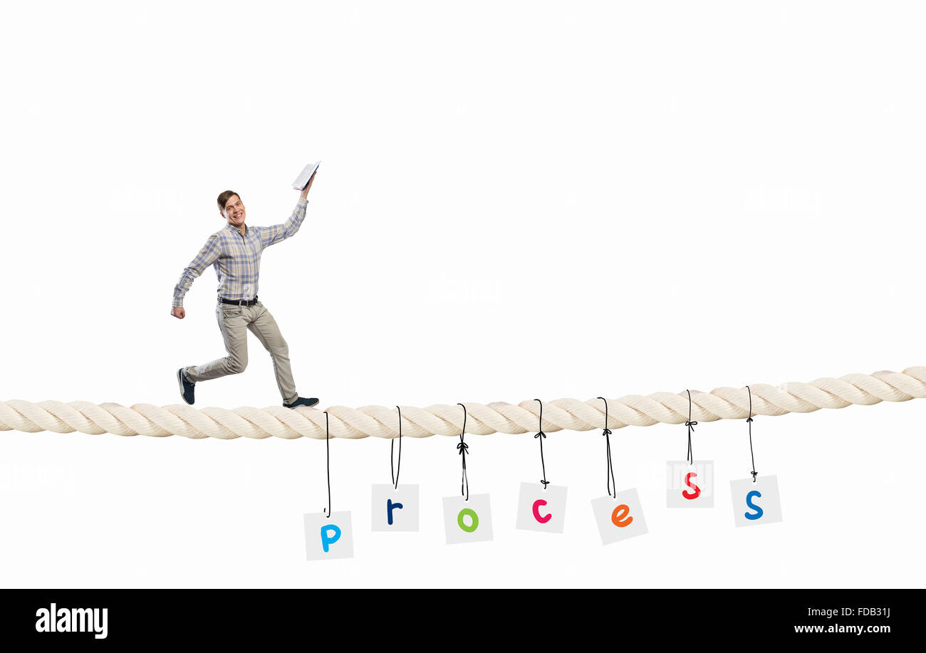 Full length of student running with book in hand Stock Photo - Alamy