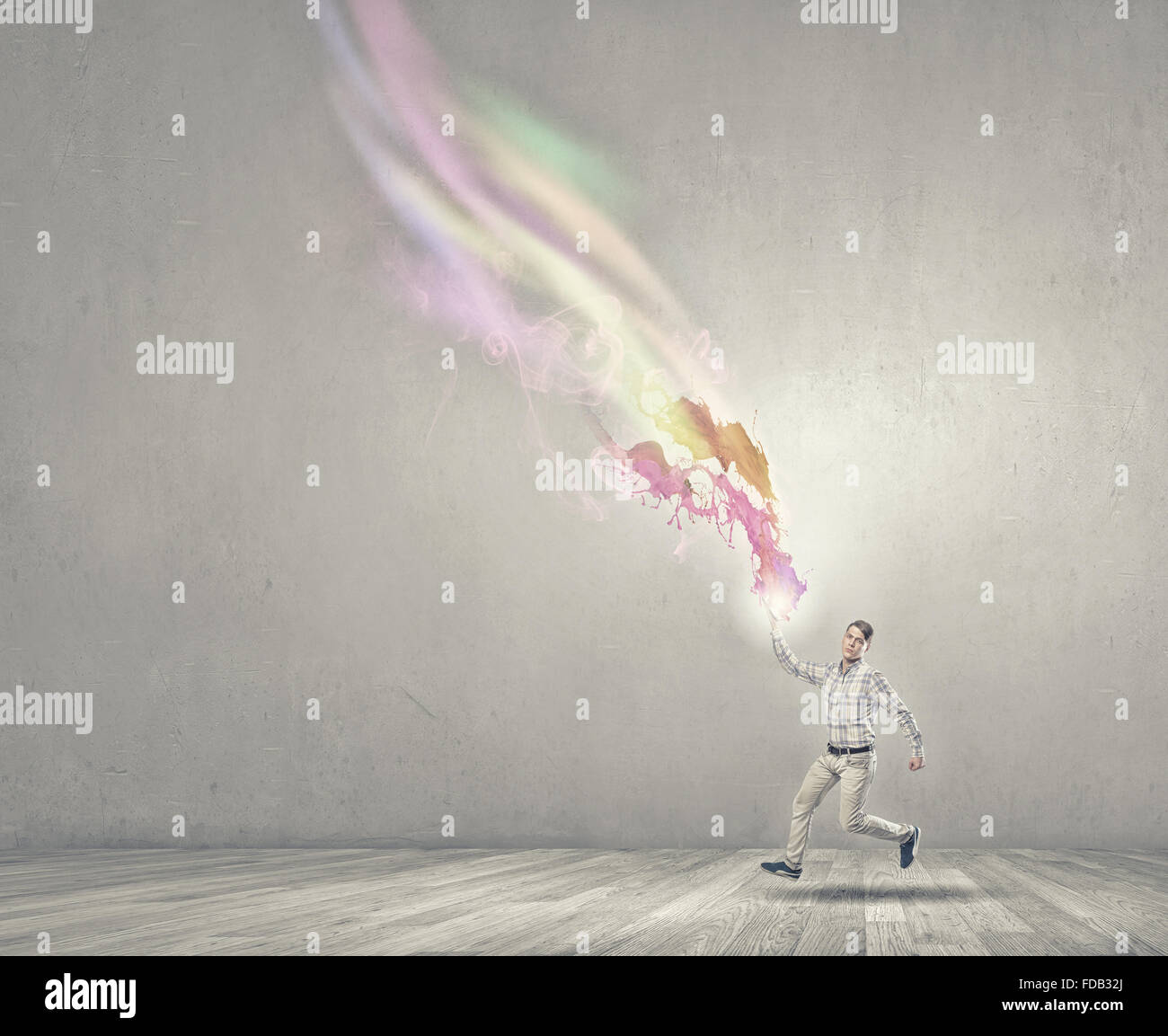 Full length of student running with book in hand Stock Photo - Alamy