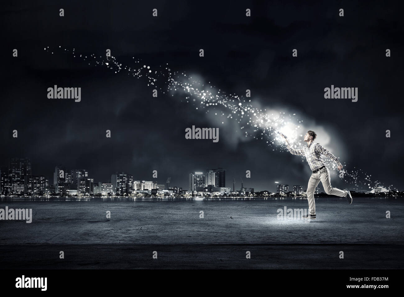 Full length of student running with book in hand Stock Photo - Alamy