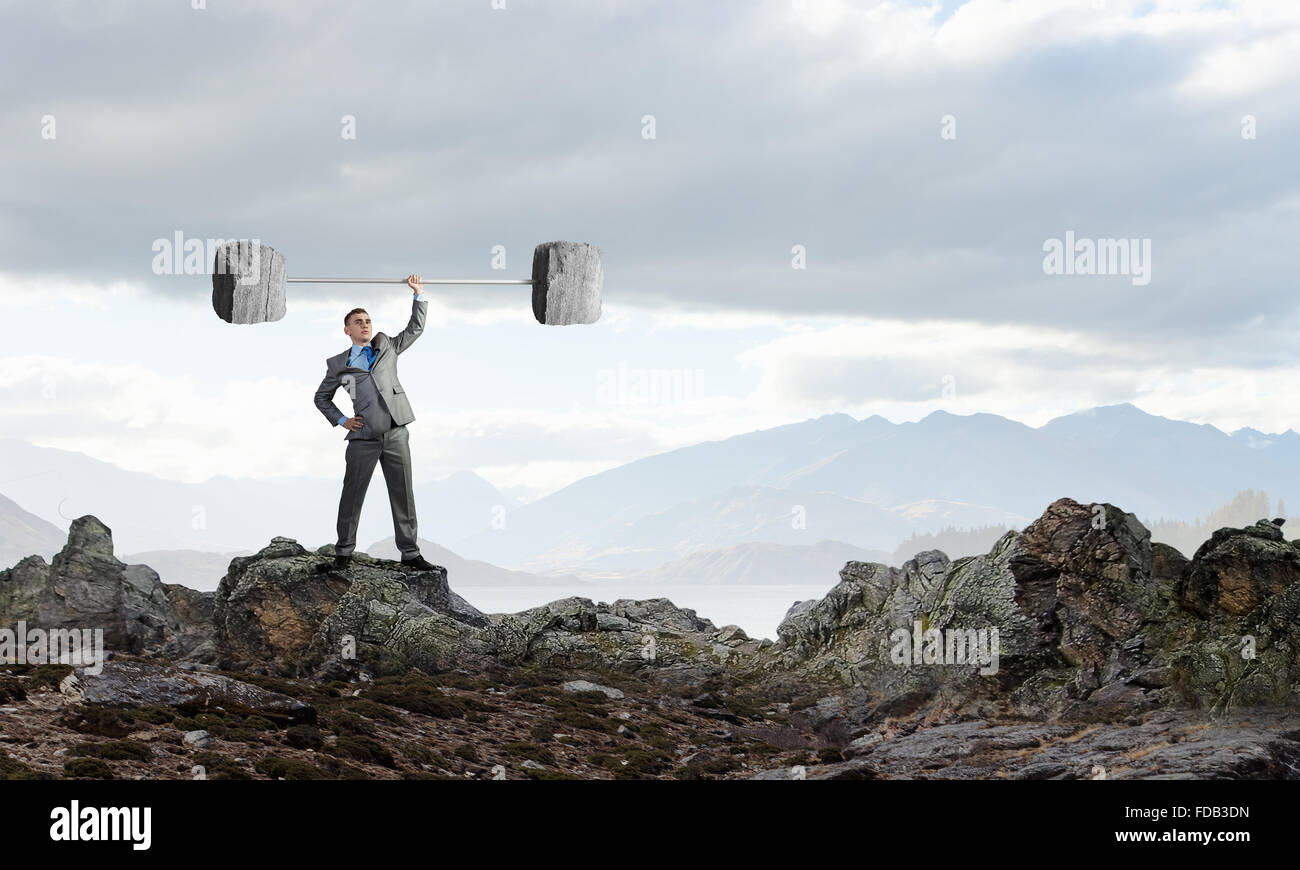 Businessman lifting rock hi-res stock photography and images - Alamy