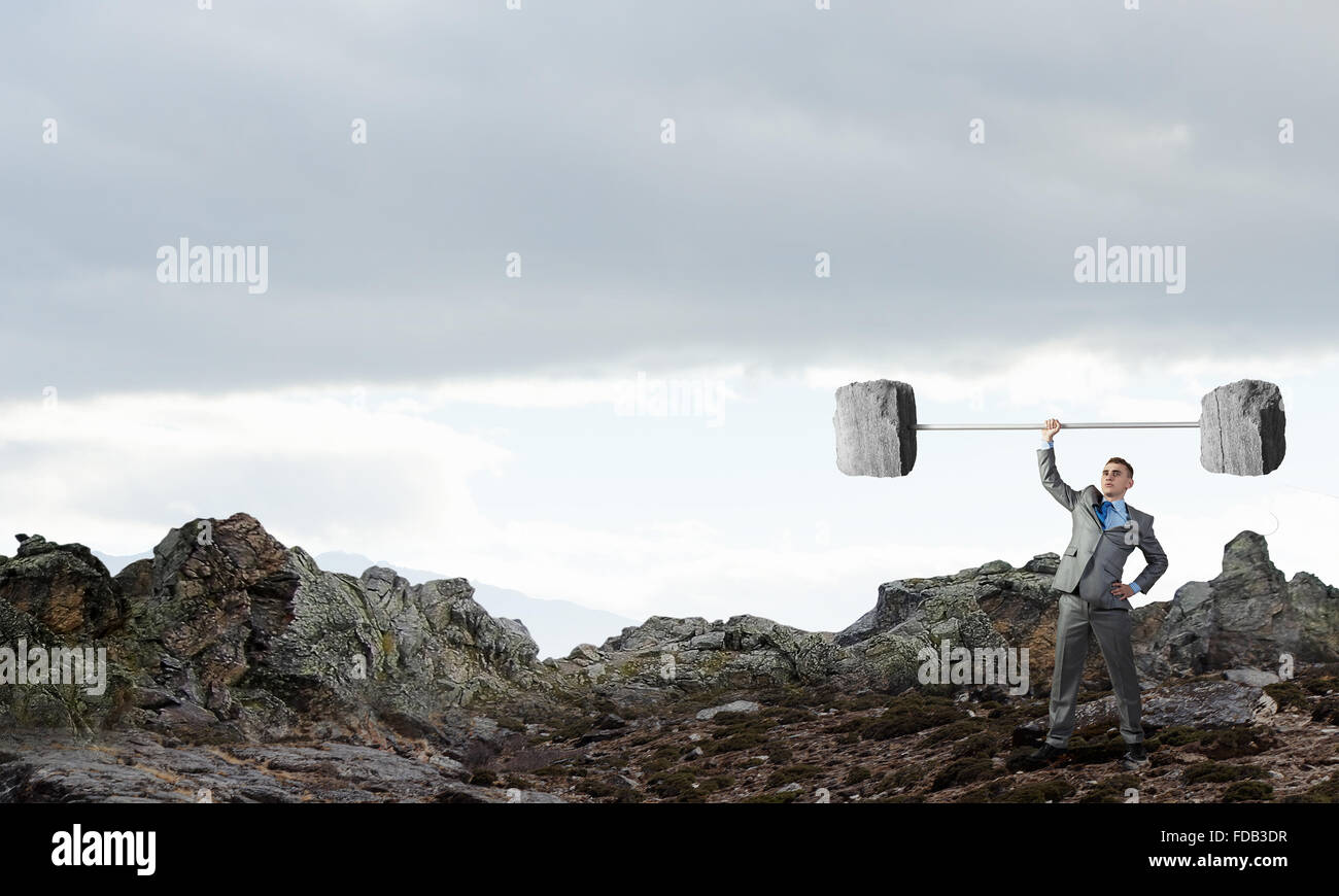 Businessman lifting rock hi-res stock photography and images - Alamy