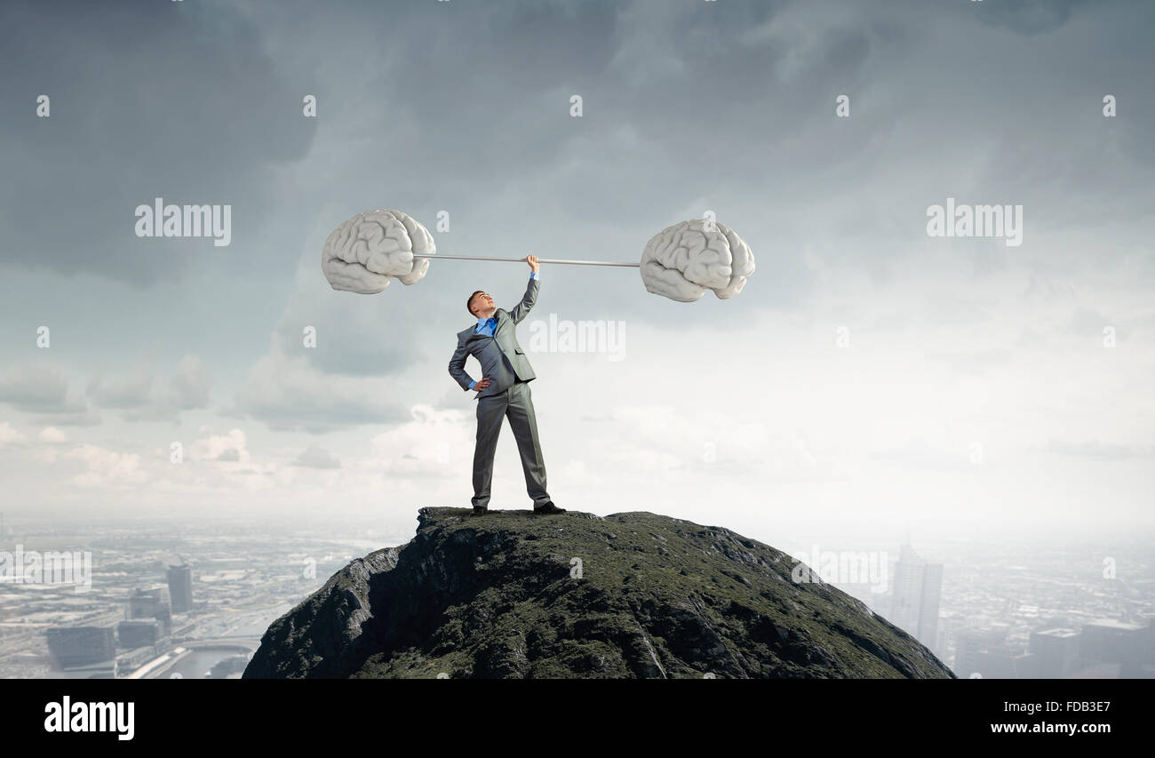 Confident businessman lifting above head barbell as symbol of great ...