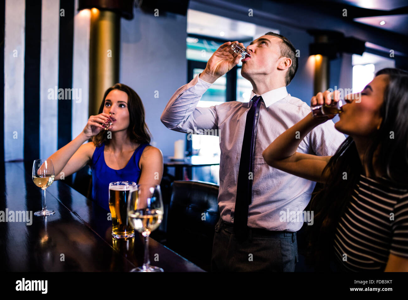 Friends drinking shots Stock Photo - Alamy
