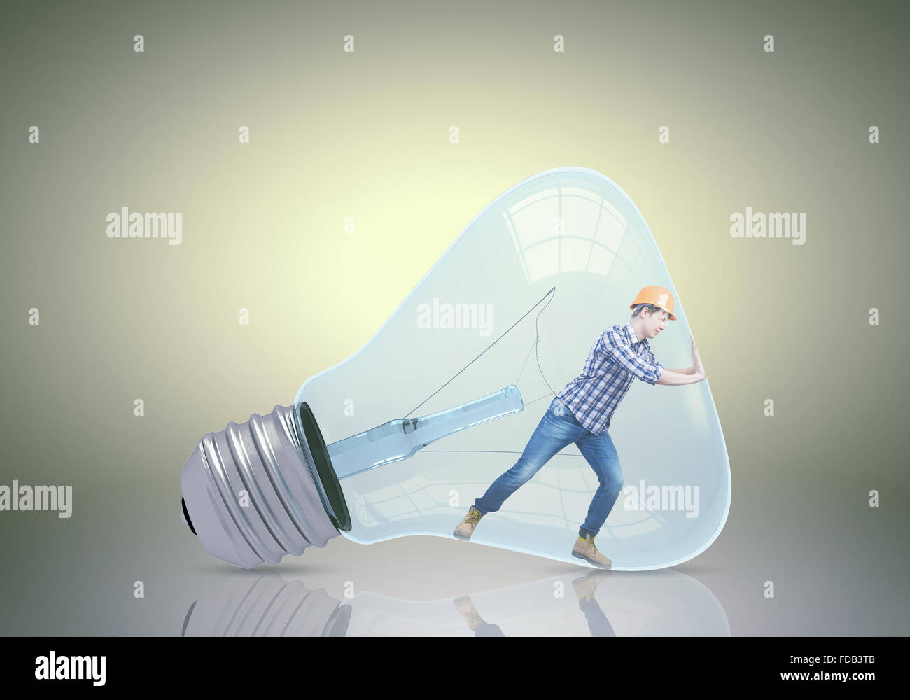 Builder man inside light bulb trying to get out Stock Photo - Alamy