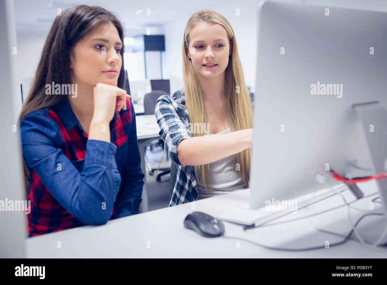Smiling students using computer Stock Photo - Alamy